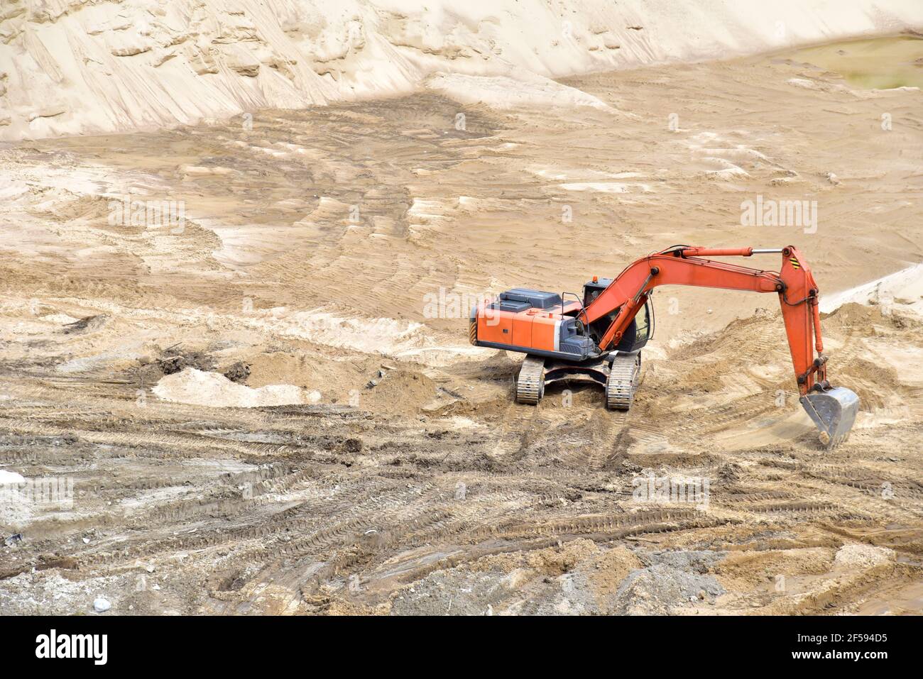 Excavator working on earthmoving at open pit mining. Backhoe digs sand ...