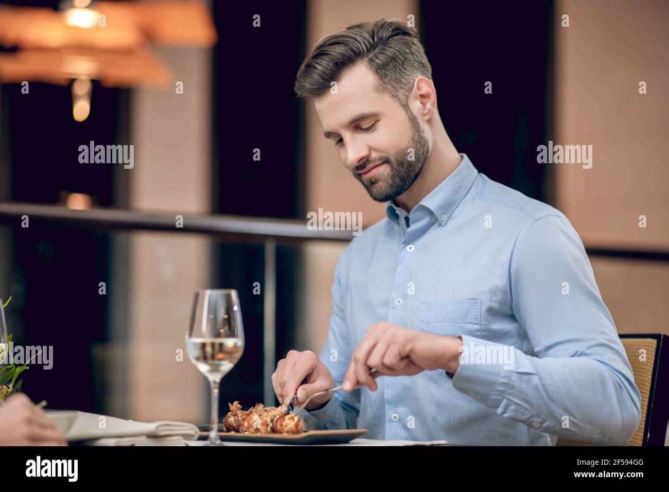 Man eating seafood at the restaurant and looking involved Stock Photo ...