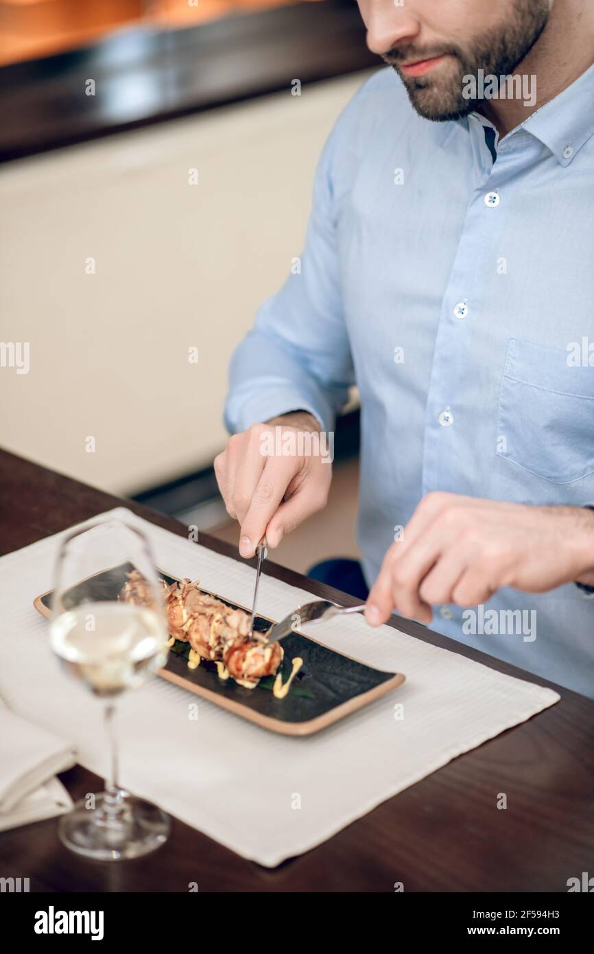Man eating seafood at the restaurant and looking involved Stock Photo ...