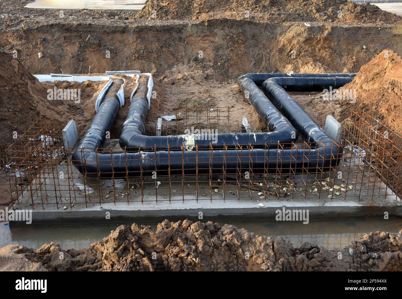 Laying of underground storm sewer pipes in ditch. Installation of water ...