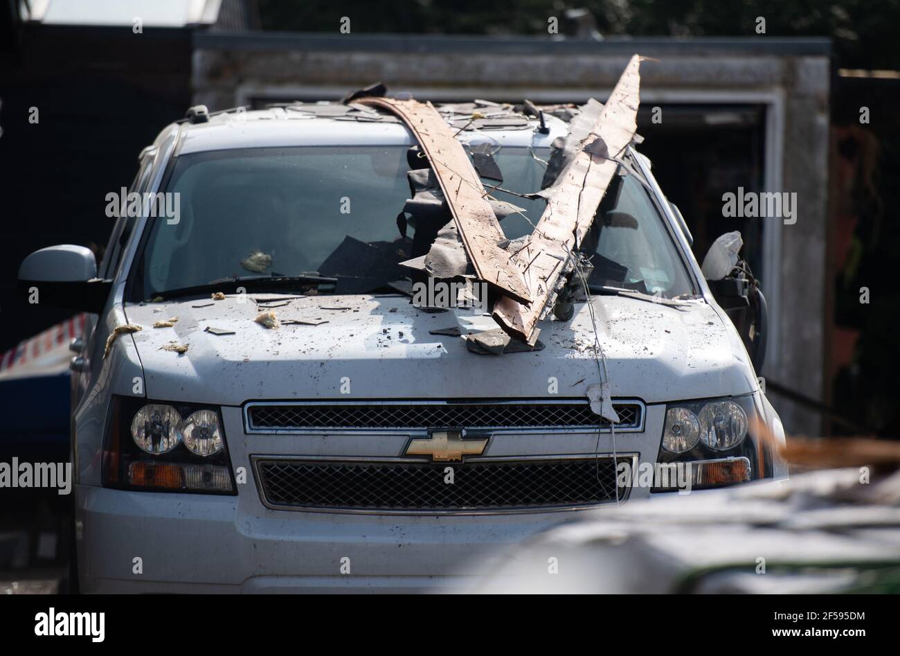 Horst, Germany. 25th Mar, 2021. Debris lies on top of a car after a ...