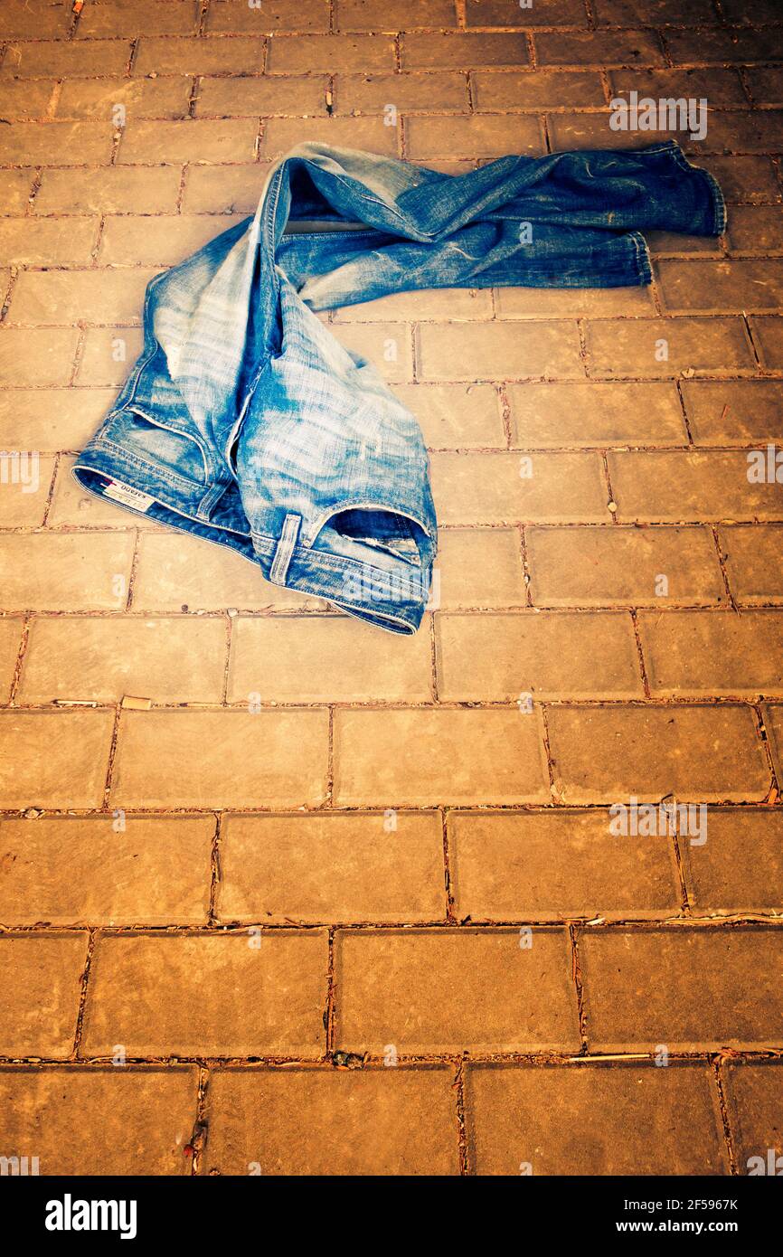 abandoned blue jeans Stock Photo - Alamy