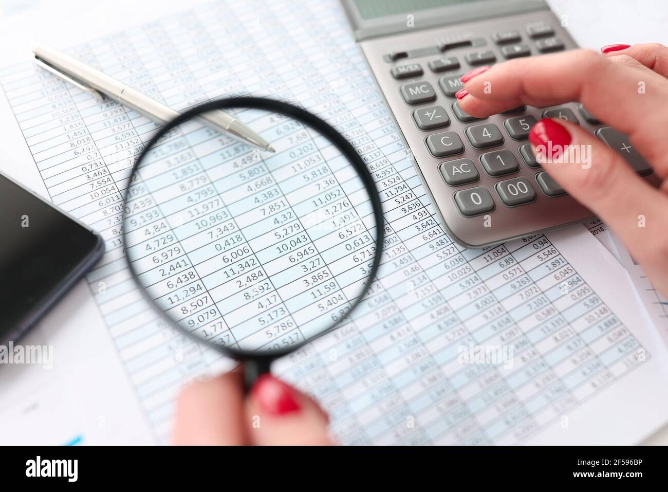 Magnifying glass over financial graph hi-res stock photography and ...