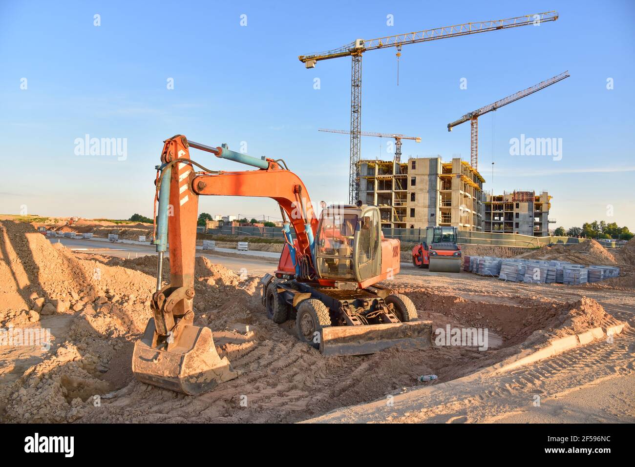 Excavator during road work at construction site. Screeding gravel for ...