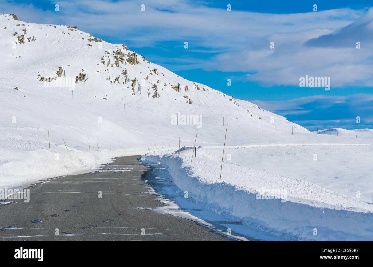 Asphalt road through snow hi-res stock photography and images - Alamy
