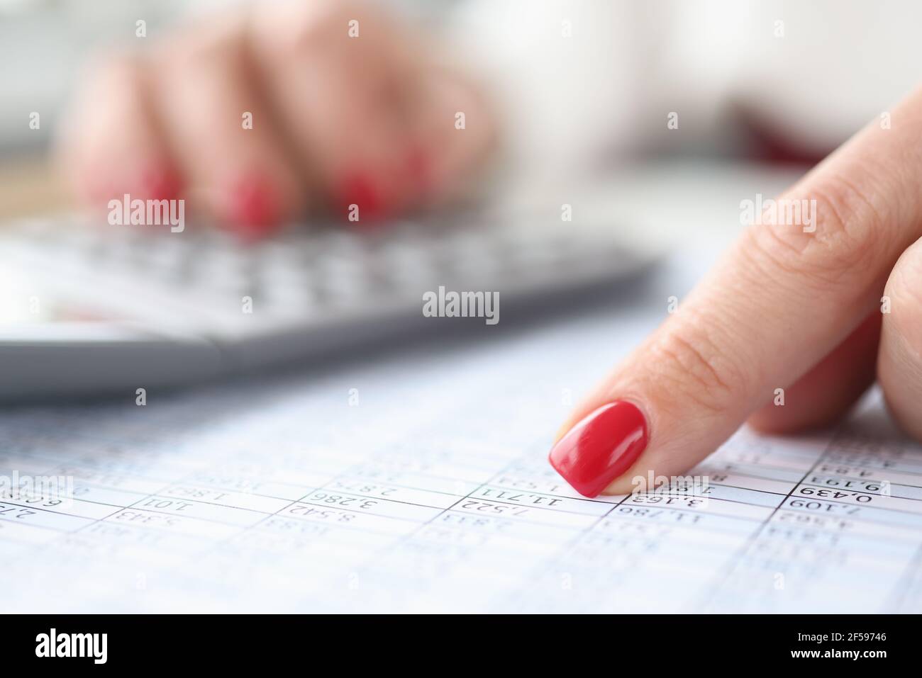Woman pointing her index finger at numbers in table and counting on ...