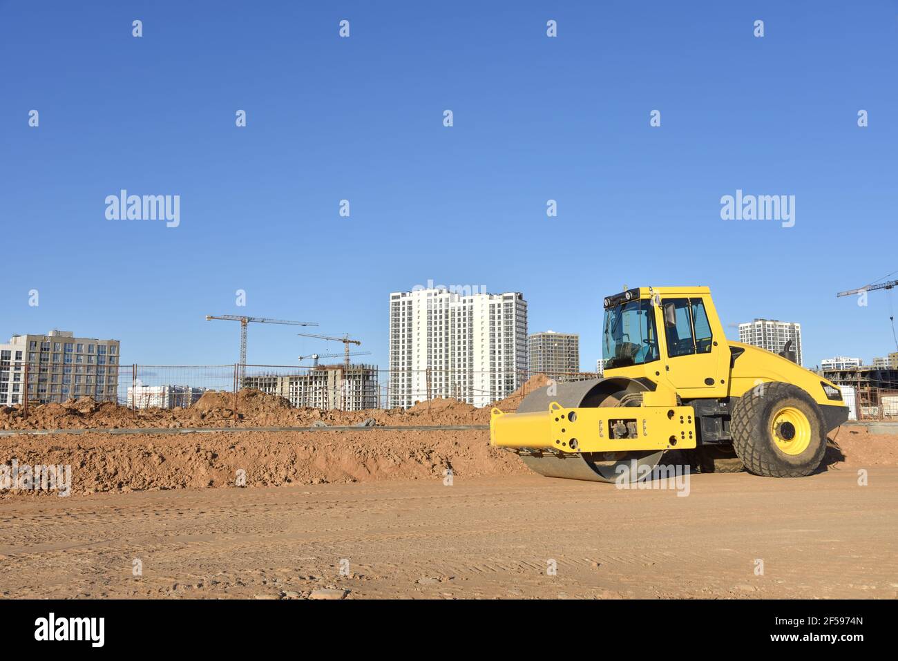 Vibro Roller Soil Compactor leveling soil at construction site ...
