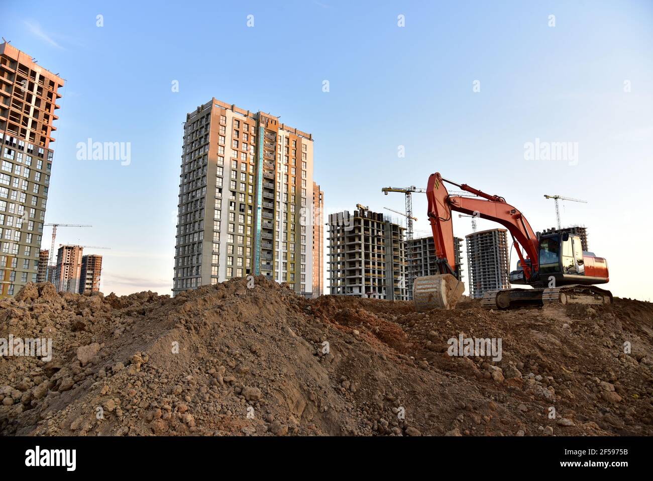 Excavator on earthmoving at construction site. Road work and Dig pit ...