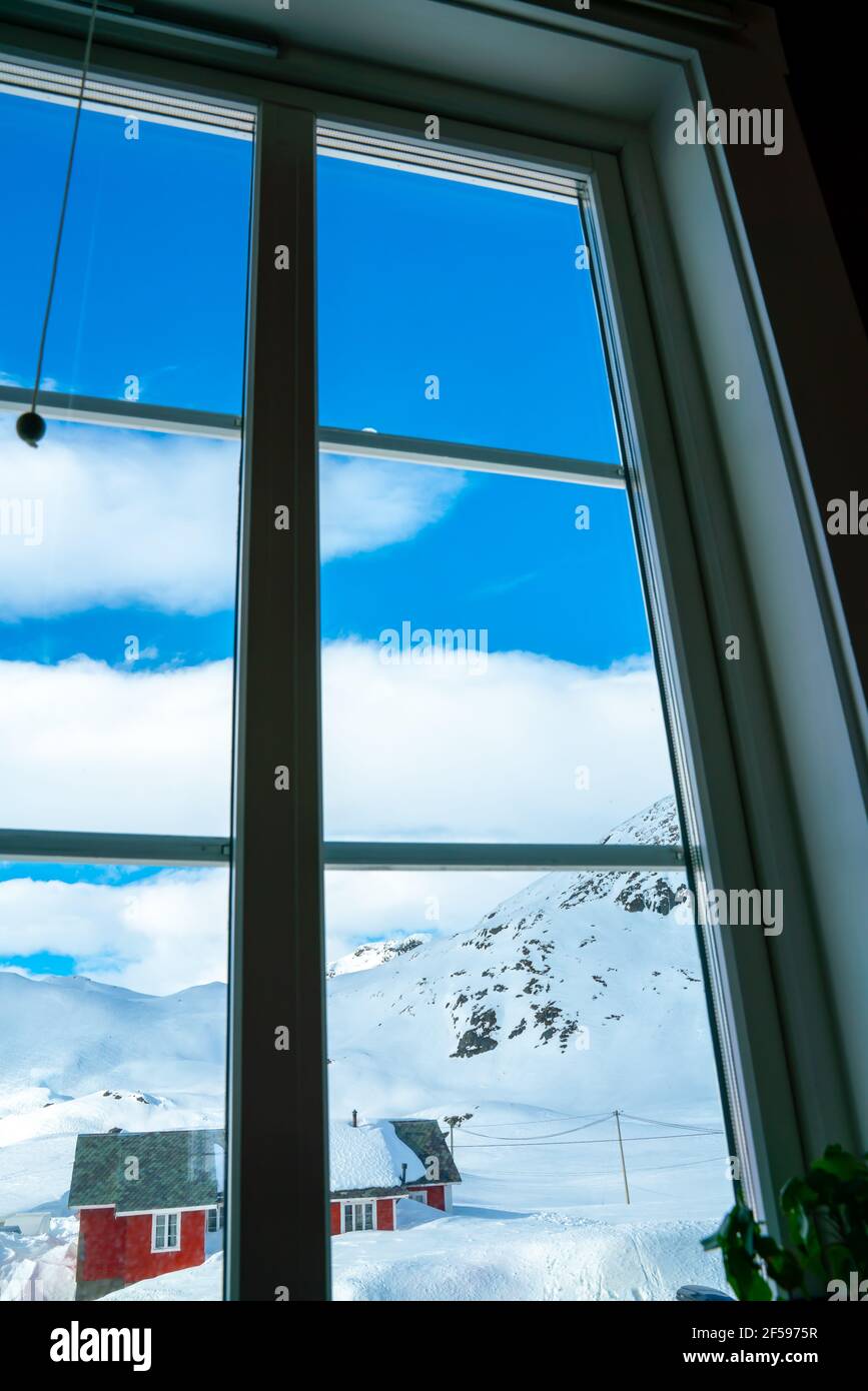 View out the window of snow capped mountains on a cold winters day ...