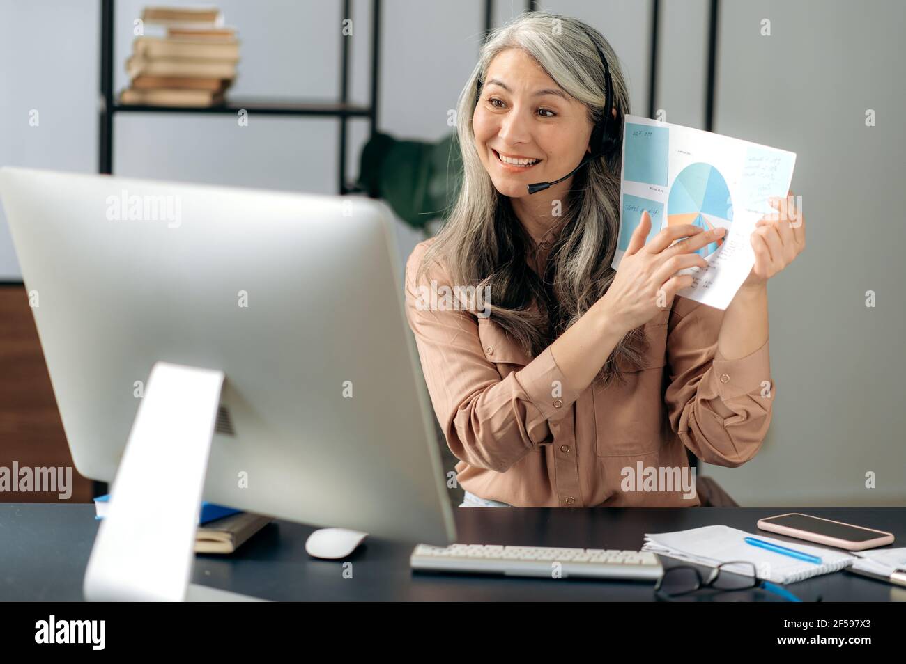 Successful intelligent Asian woman, top manager, ceo, financial tutor ...