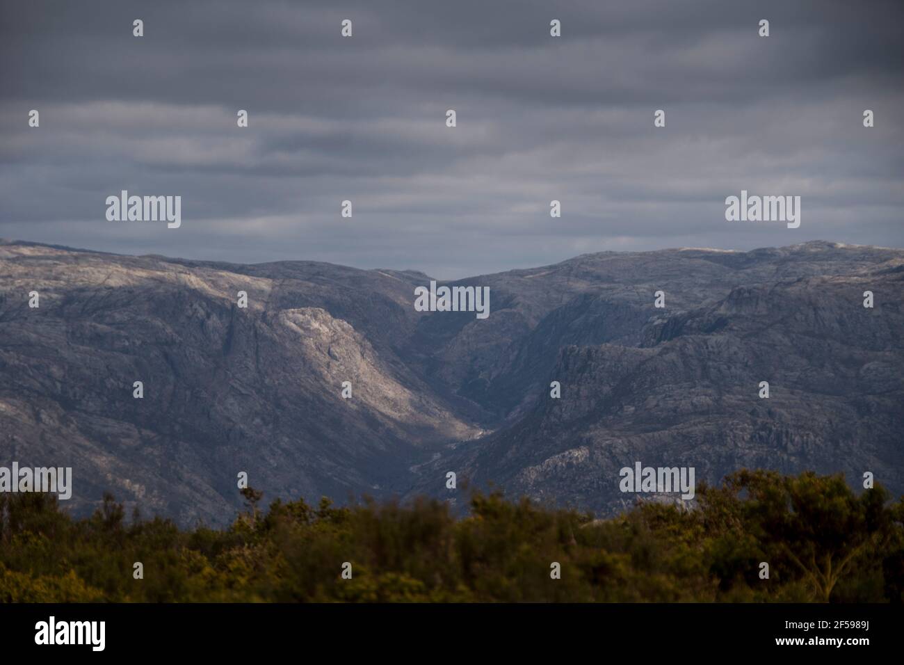 Mountain rocky landscape in a cloudy spring day, as the shadow from the ...