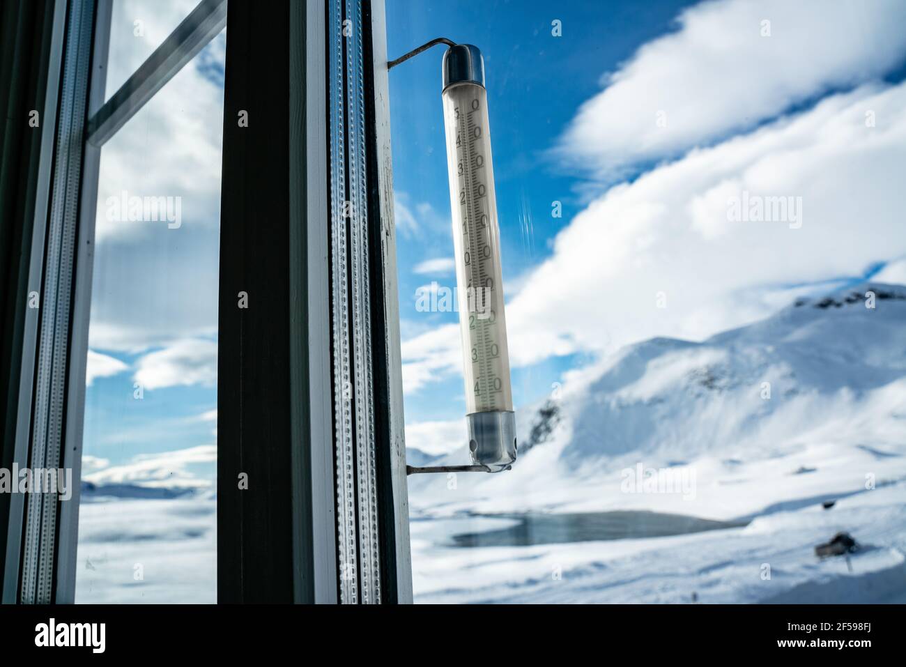 Window mounted thermometer in the arctic highland with snow capped ...