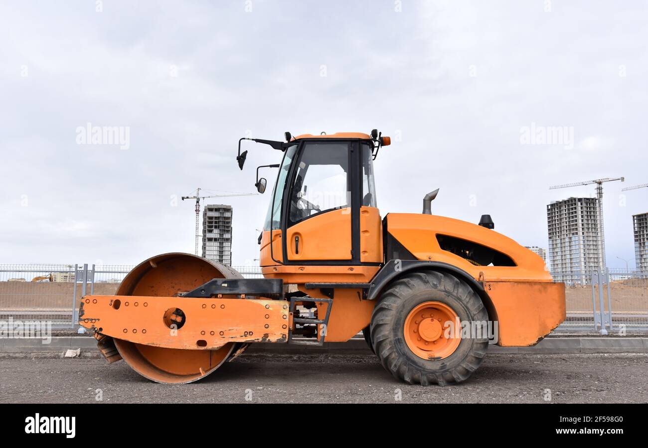 Vibro Roller Soil Compactor leveling soil at construction site ...