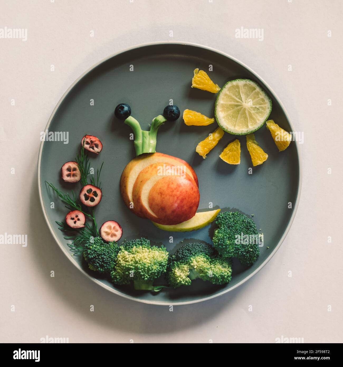 shape of snail and sun from colorful vegetables on the plate Stock ...