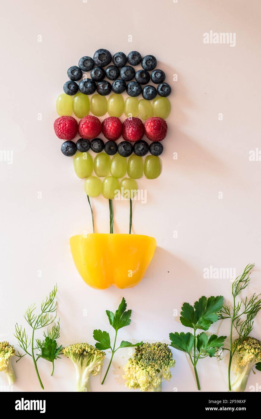 shape of balloon made out from colorful vegetables and frutis as grape ...