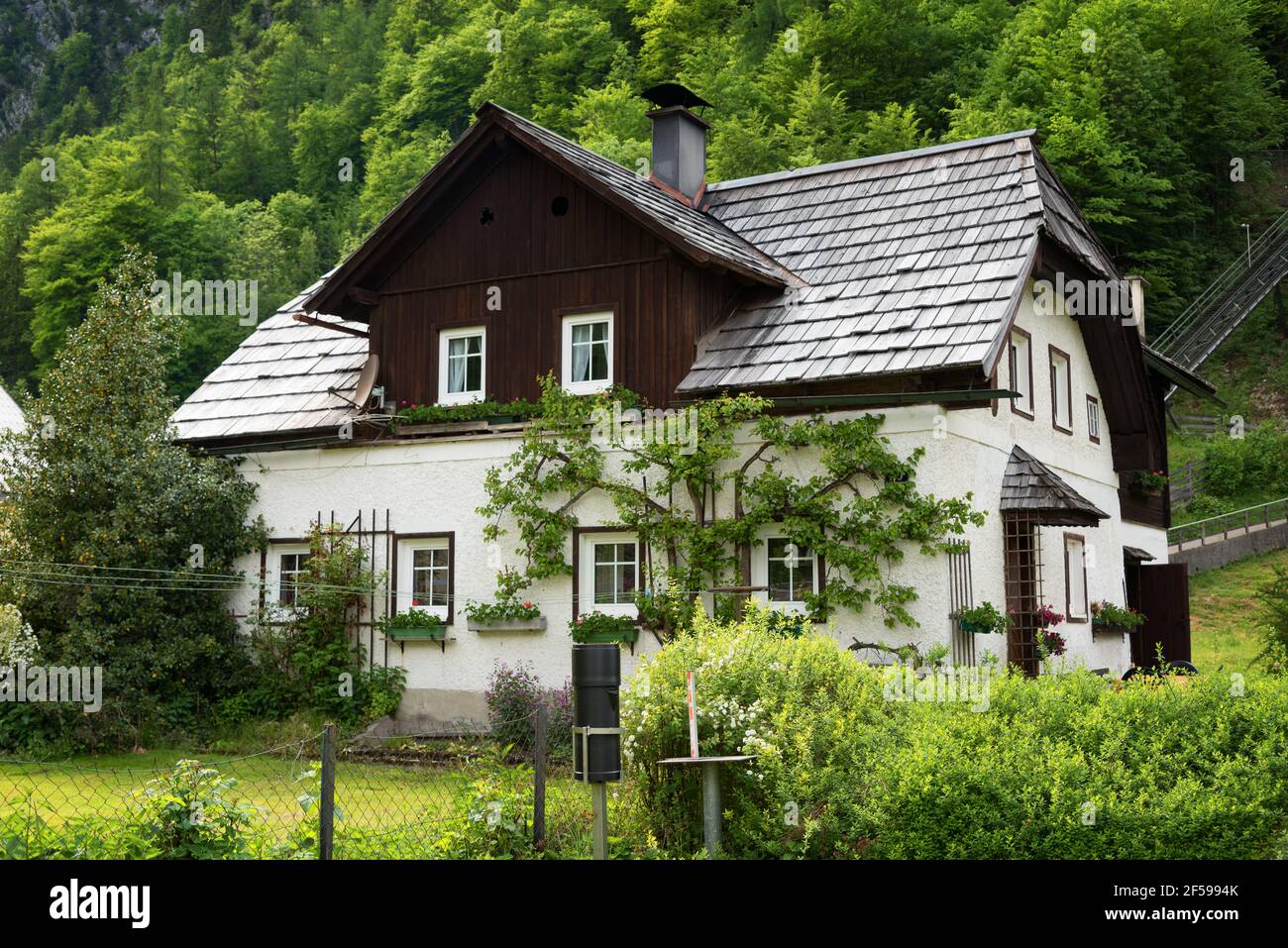 Typical Austrian Alpine house with bright flowers, Hallstatt, Austria ...