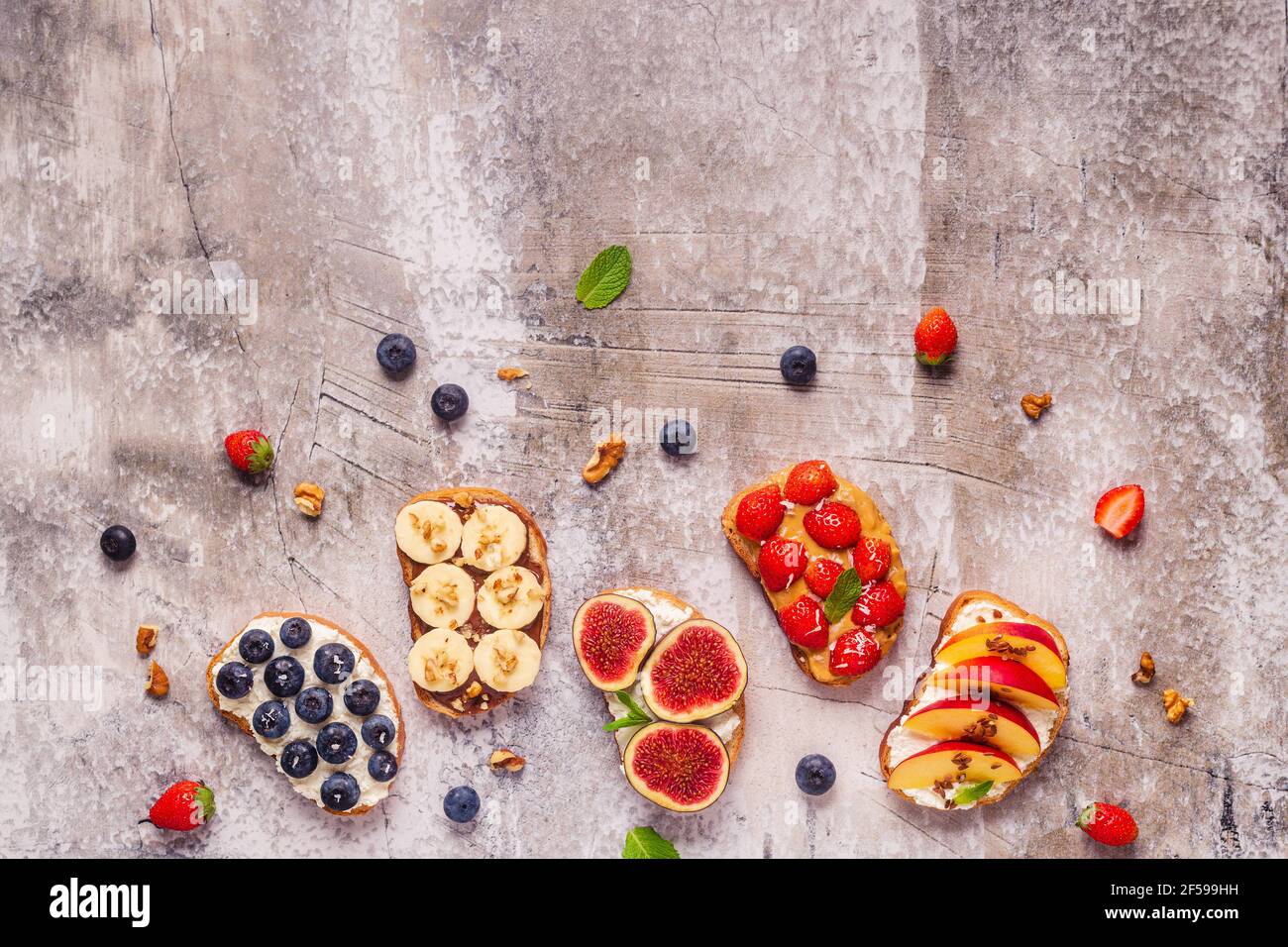 Homemade summer toast with cream cheese, nut butter and fruits and ...