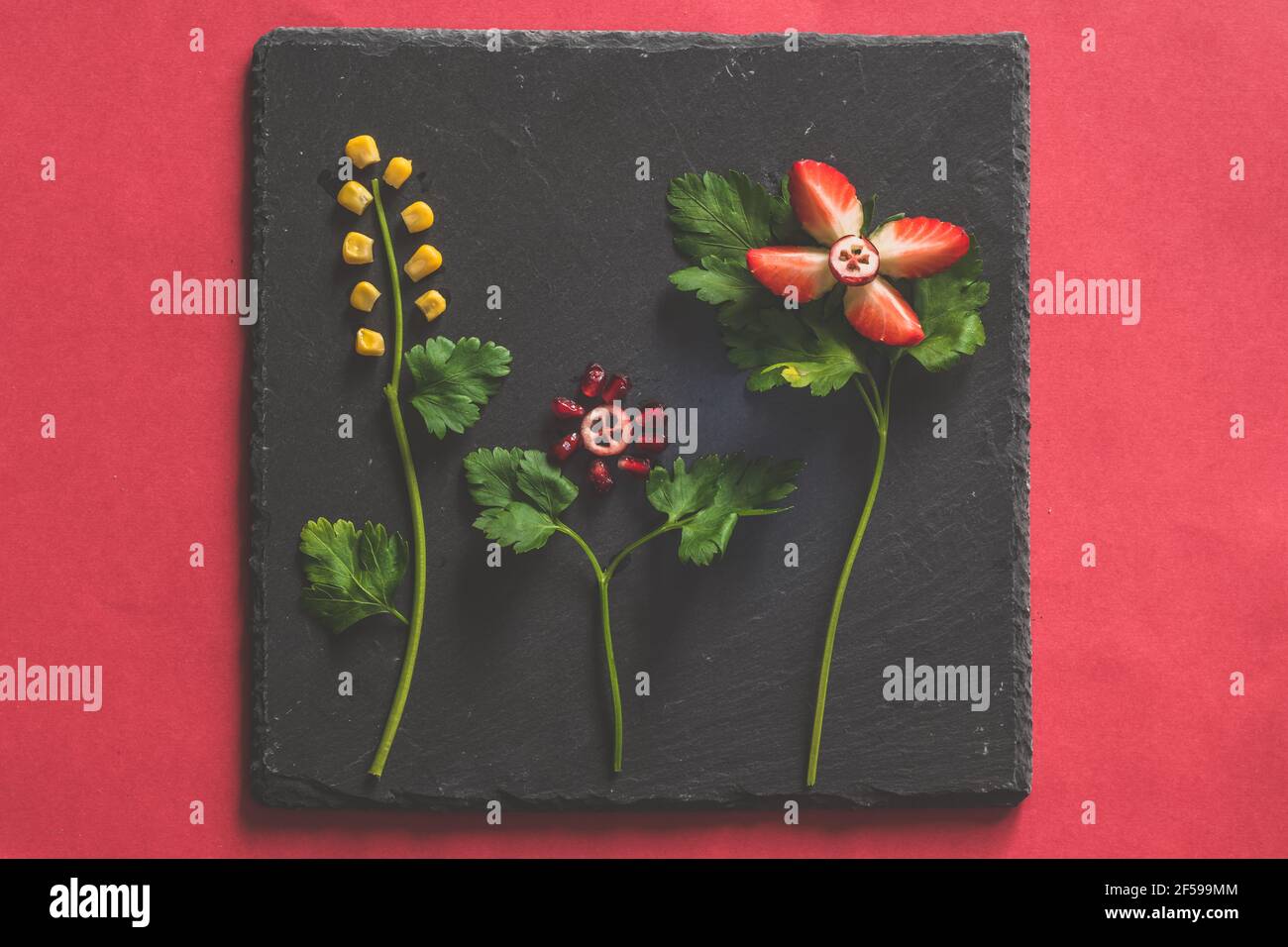 fruit and vegetable creative ideas on black shale background, flower ...