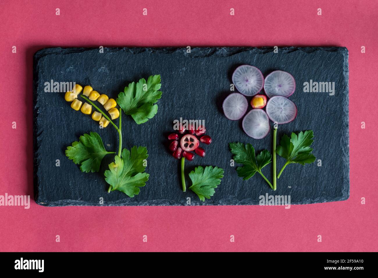 fruit and vegetable creative ideas on black shale background, flower ...