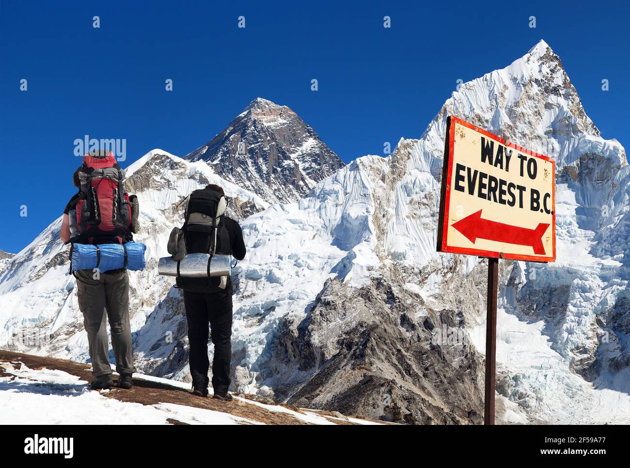Panoramic view of Mount Everest from Kala Patthar with two tourists and ...