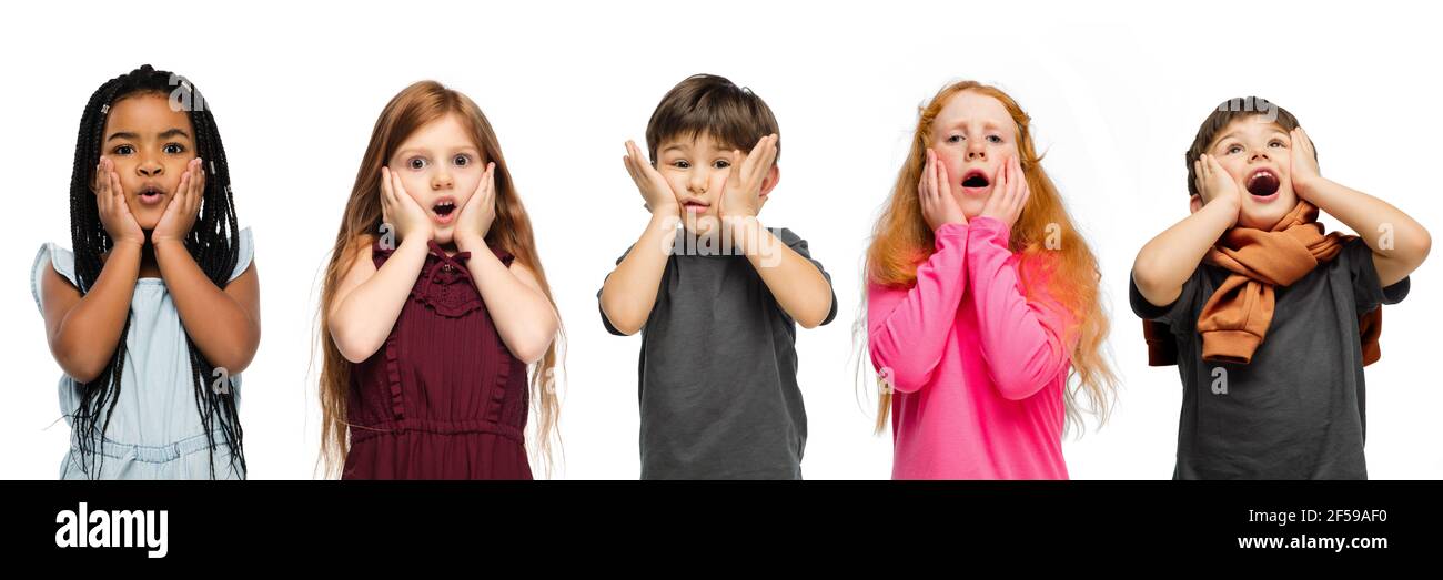 Little and happy kids gesturing isolated on white studio background ...