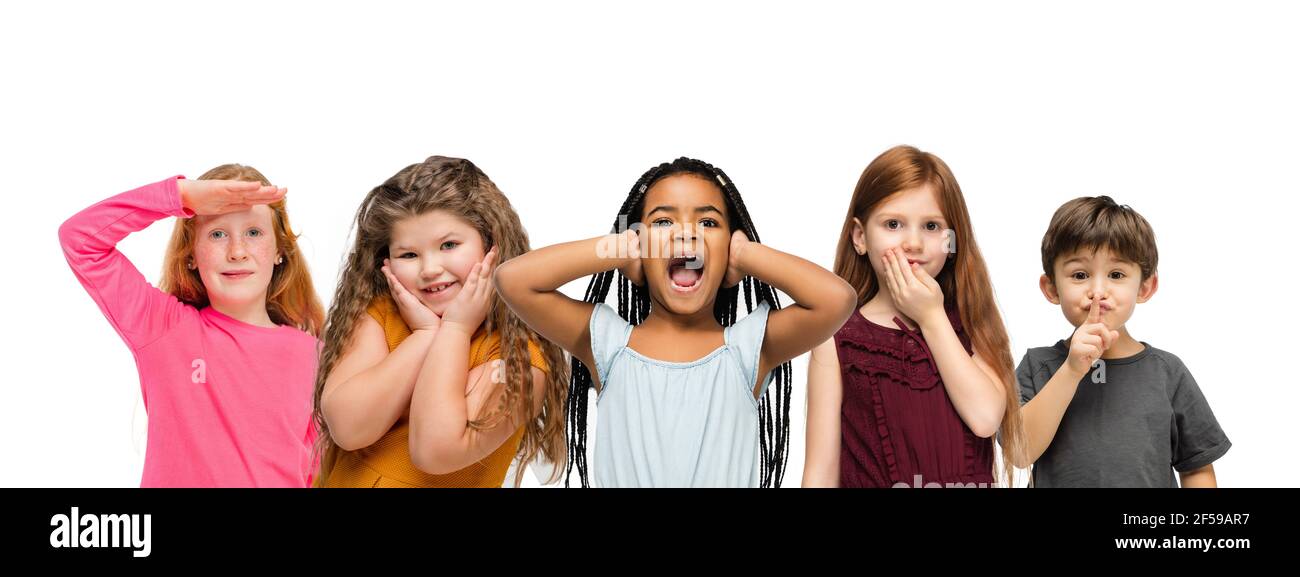 Little and happy kids gesturing isolated on white studio background ...