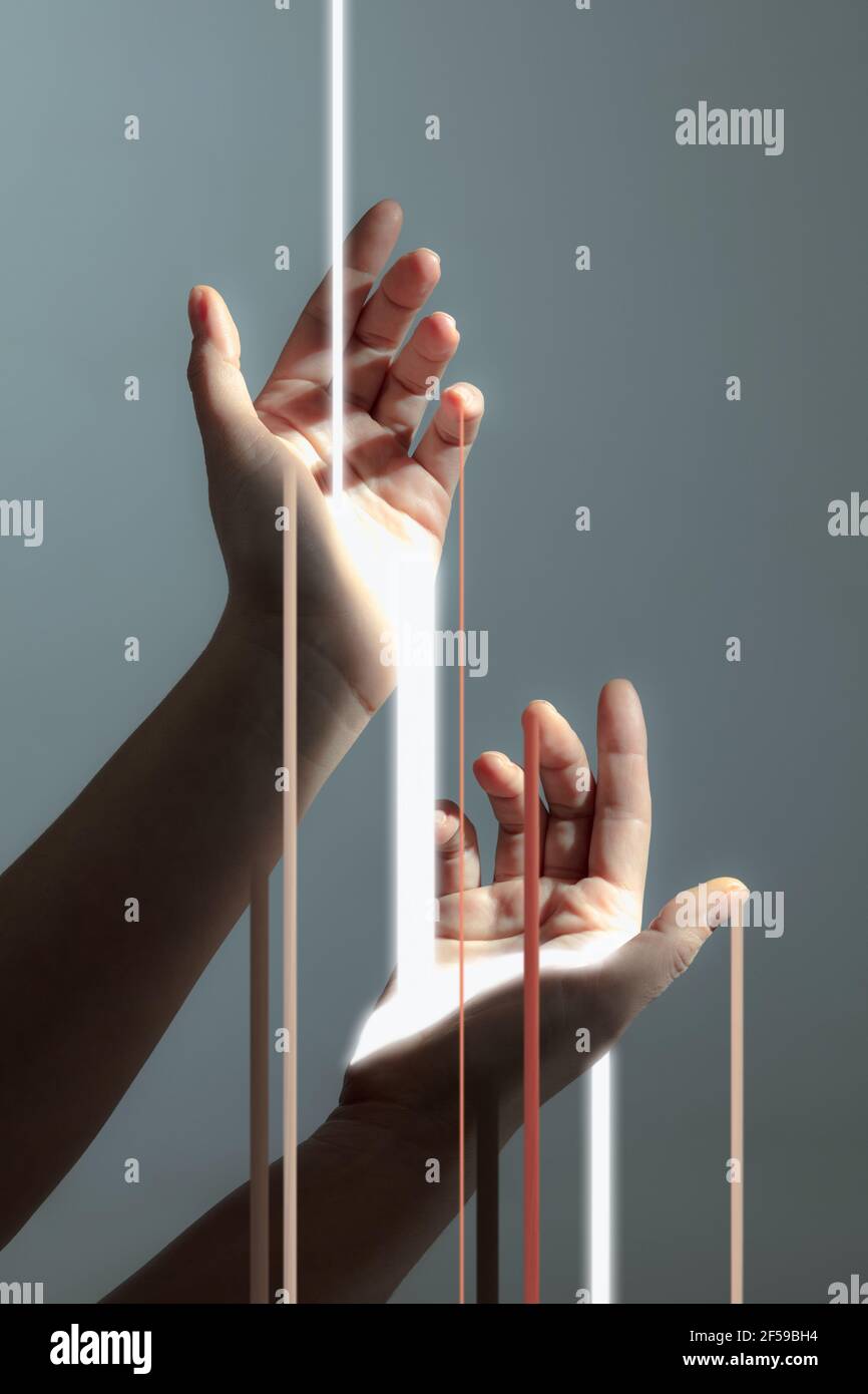 Light rays passing through human hands isolated on light grey ...
