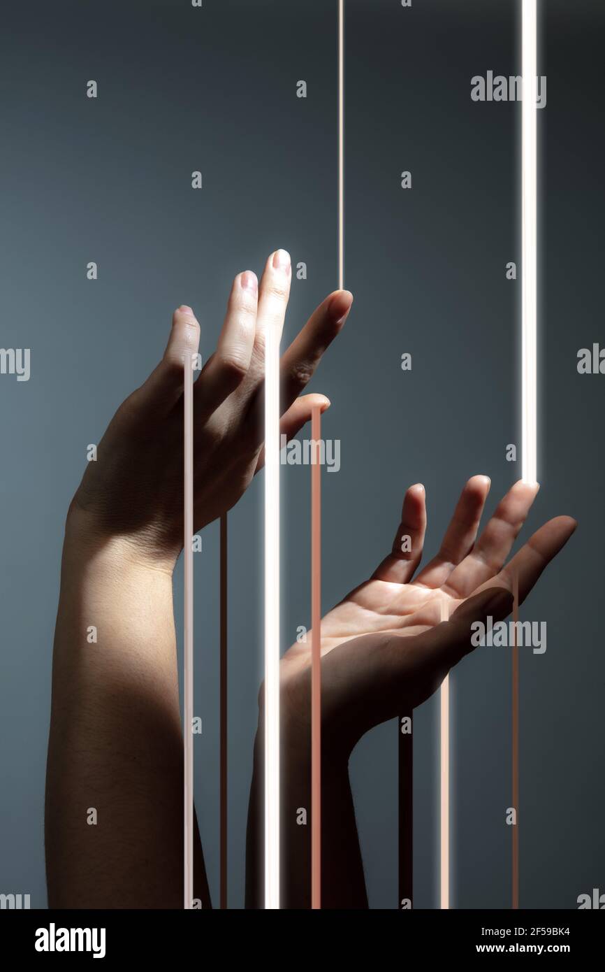 Light rays passing through human hands isolated on light grey ...