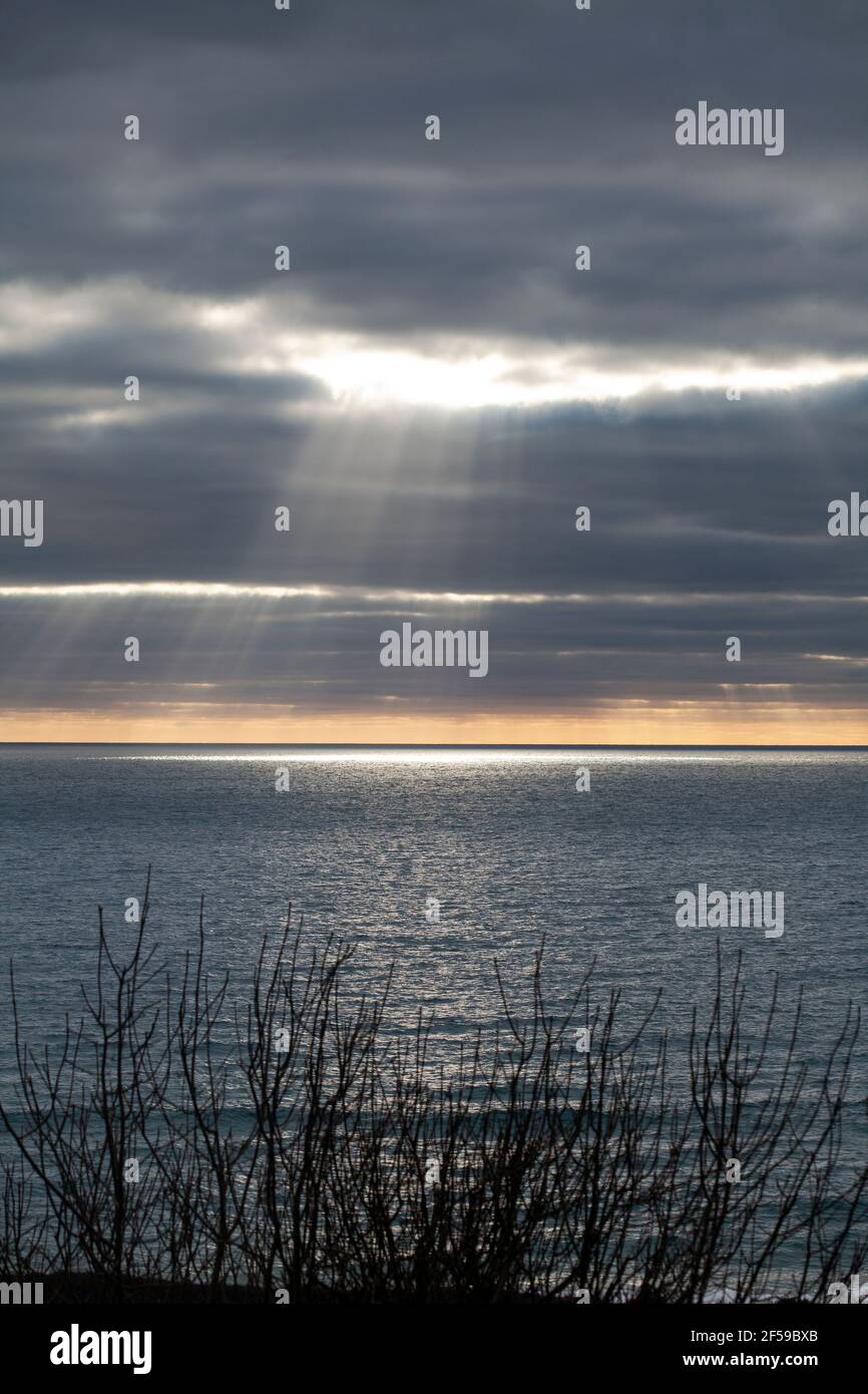 Sun rays through storm clouds hi-res stock photography and images - Alamy