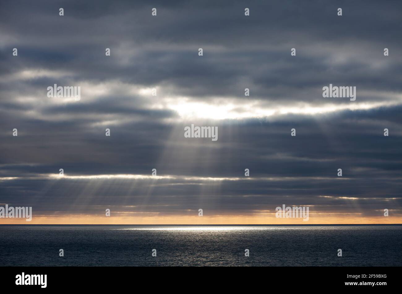 Sun shines through rain clouds hi-res stock photography and images - Alamy