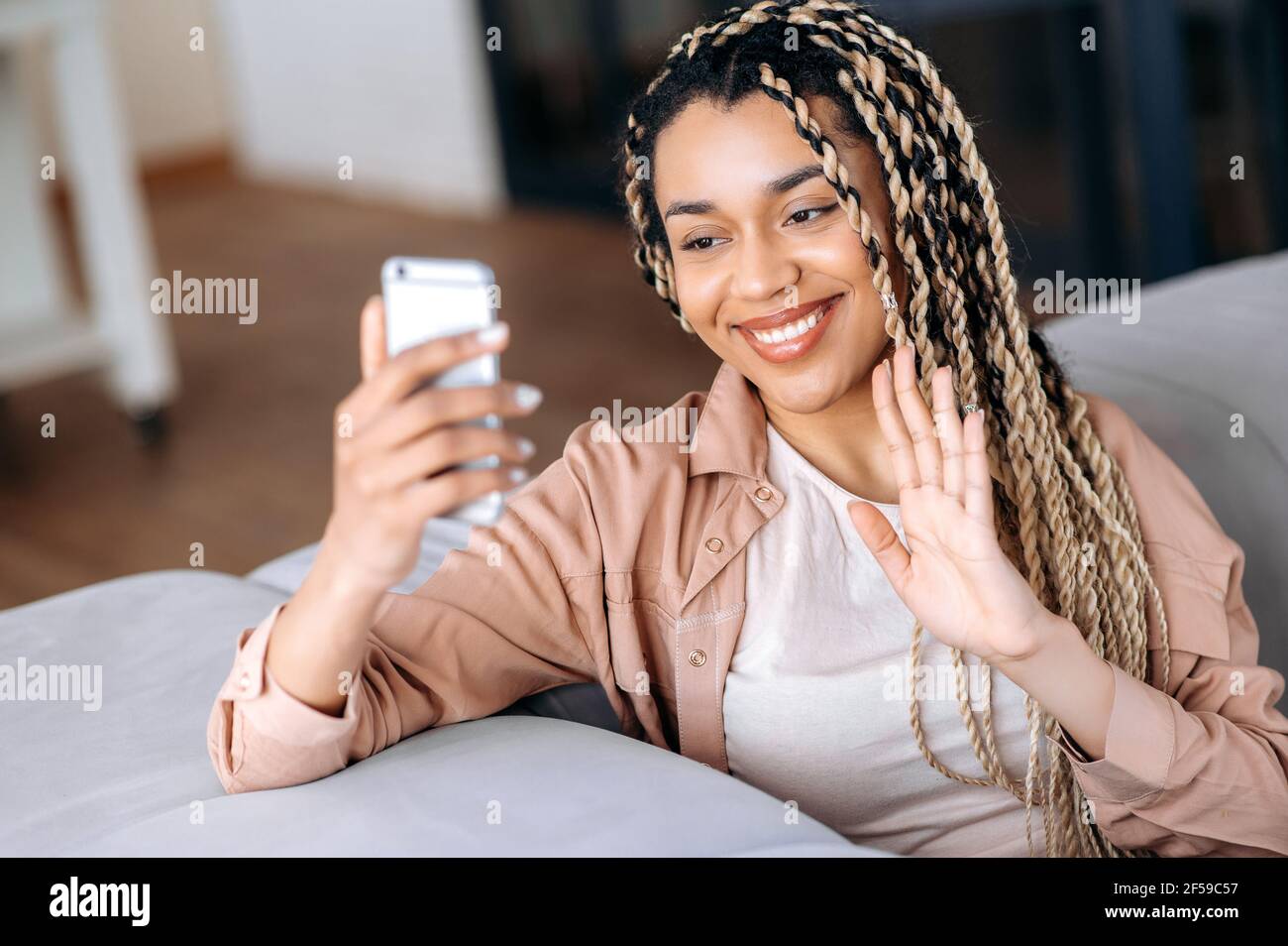Online communication by smartphone. Cheerful smiling african american ...