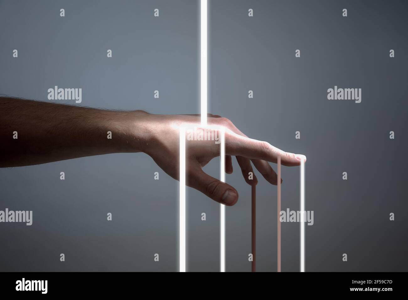 Light rays passing through delicate female hand isolated over grey ...