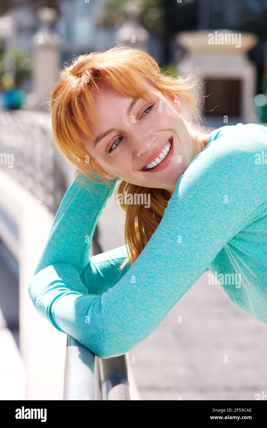 Sporty woman leaning on railing hi-res stock photography and images - Alamy