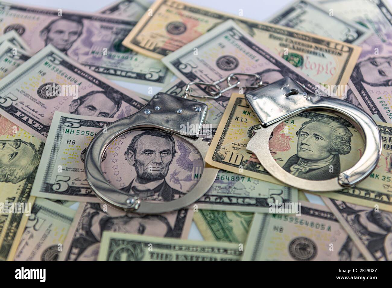 handcuffs on money background, dollar bills, money cash corruption ...