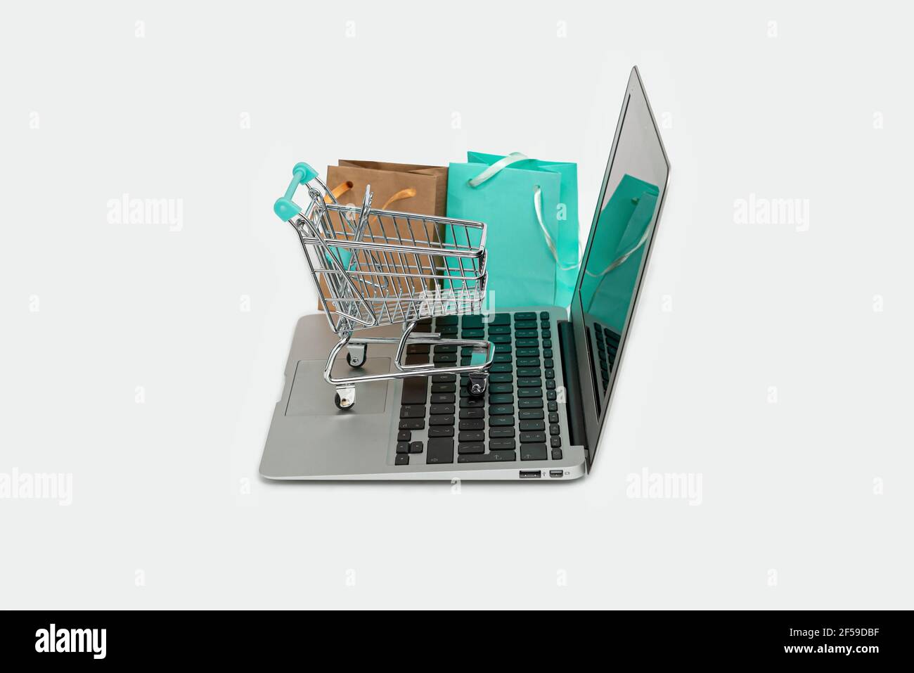 online shopping concept with laptop computer, shopping bag and trolley ...