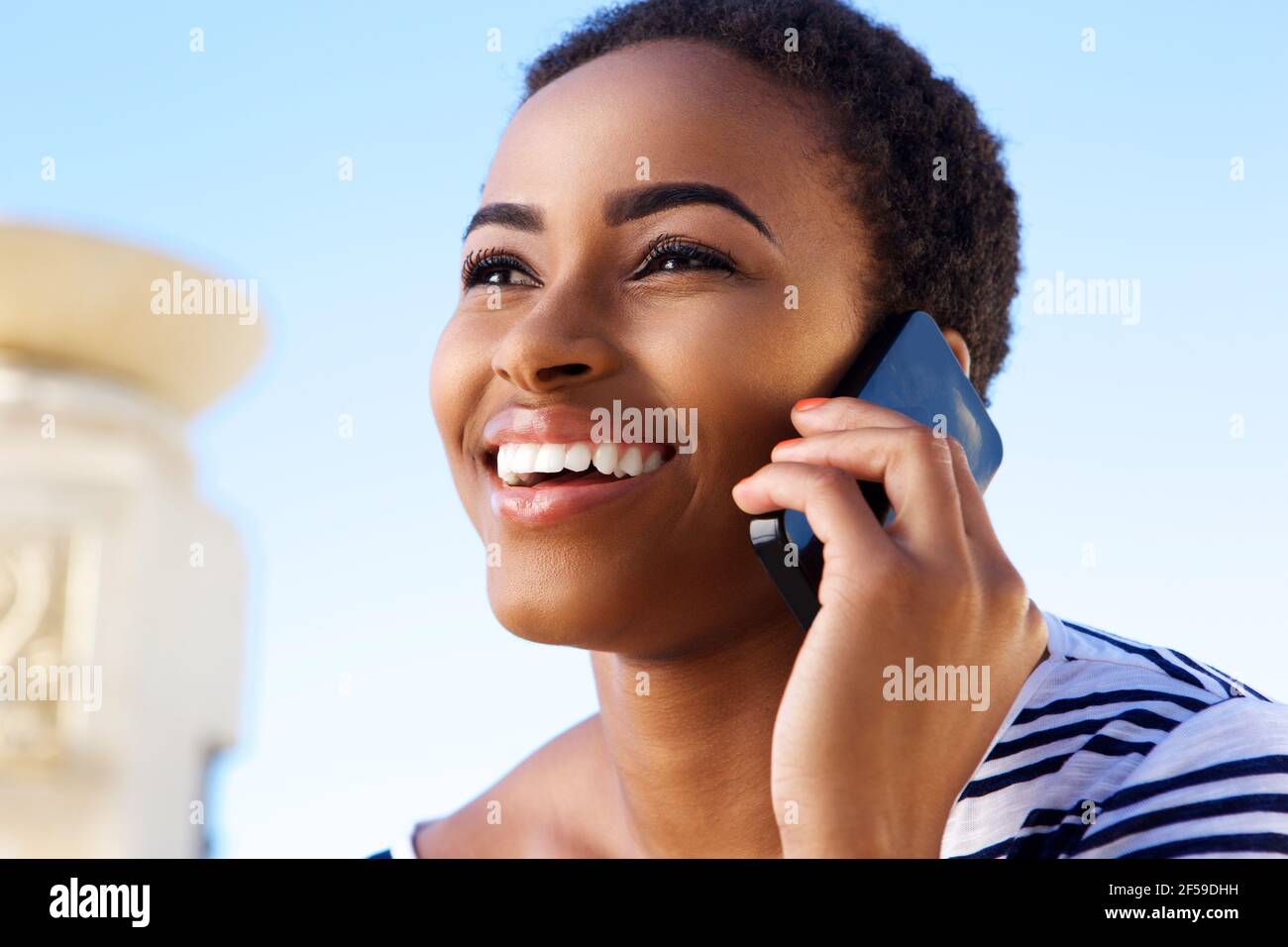 Smiling young african woman talking hi-res stock photography and images ...