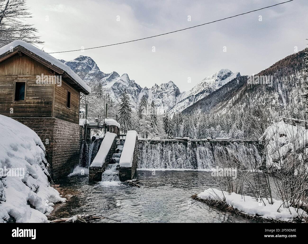 Waterfall on small dam in mountains. Winter, snow, nature, idyllic ...