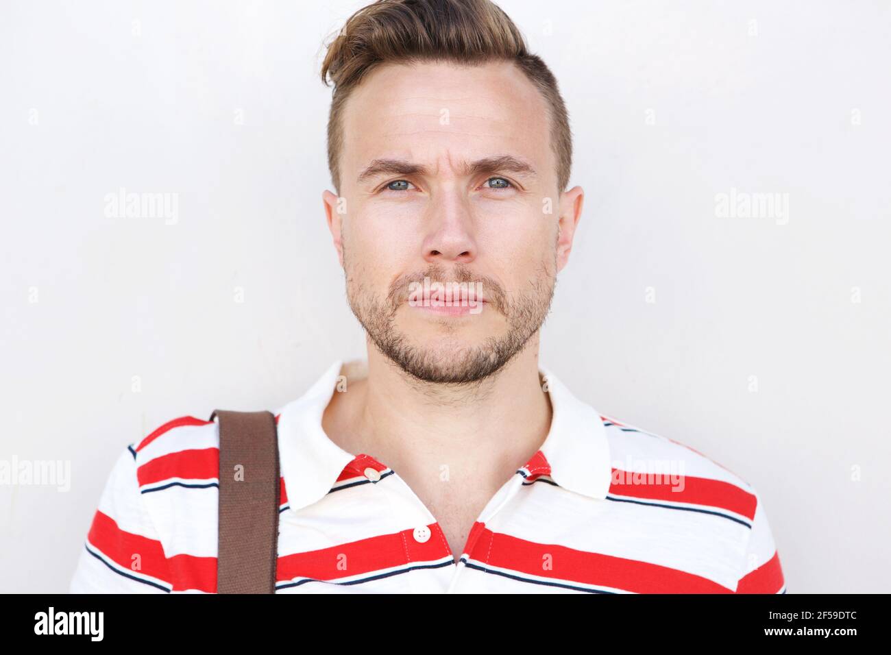 Close up portrait of handsome young man with serious expression ...