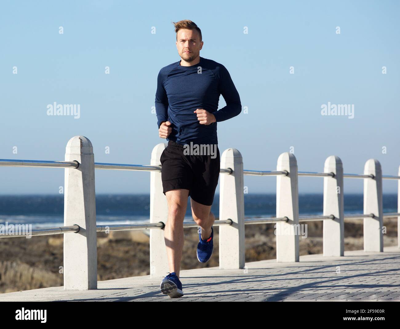 Full body portrait of healthy young man going for a run outside Stock ...