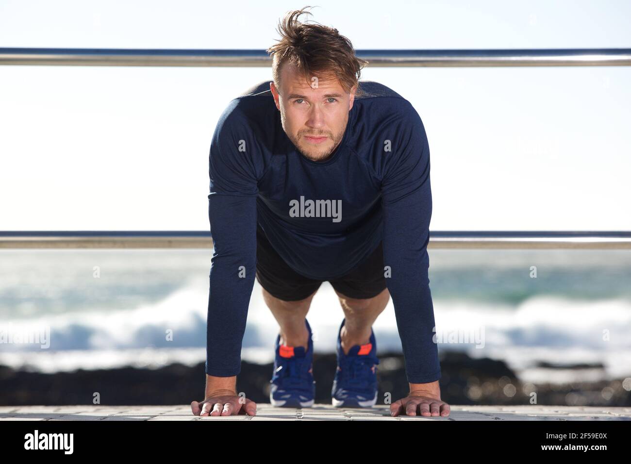 Portrait of handsome young man doing push ups outdoors Stock Photo - Alamy