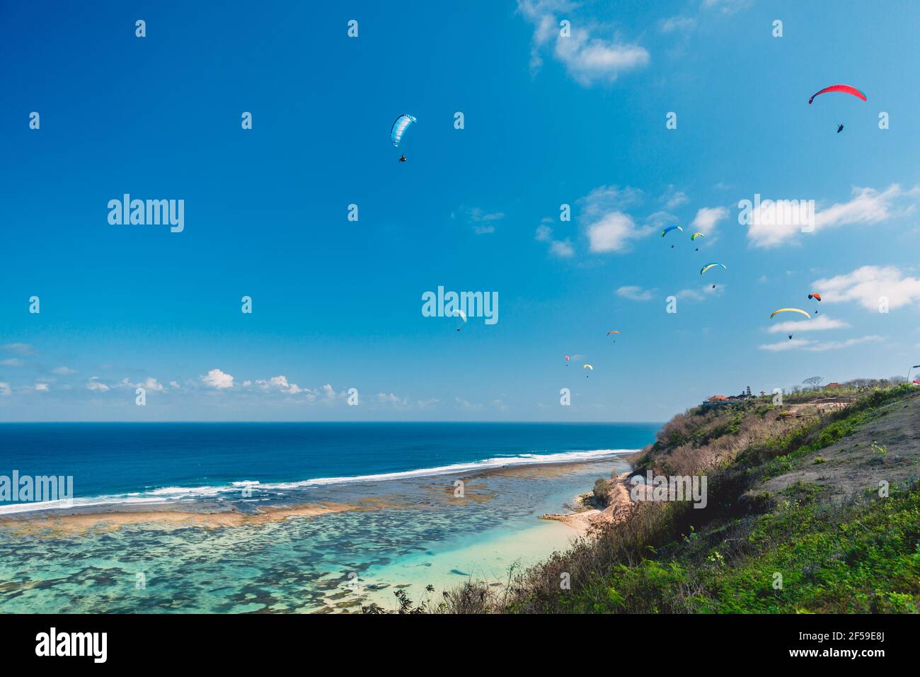 Tropical coast and blue ocean with paraglider in tropical island Stock ...