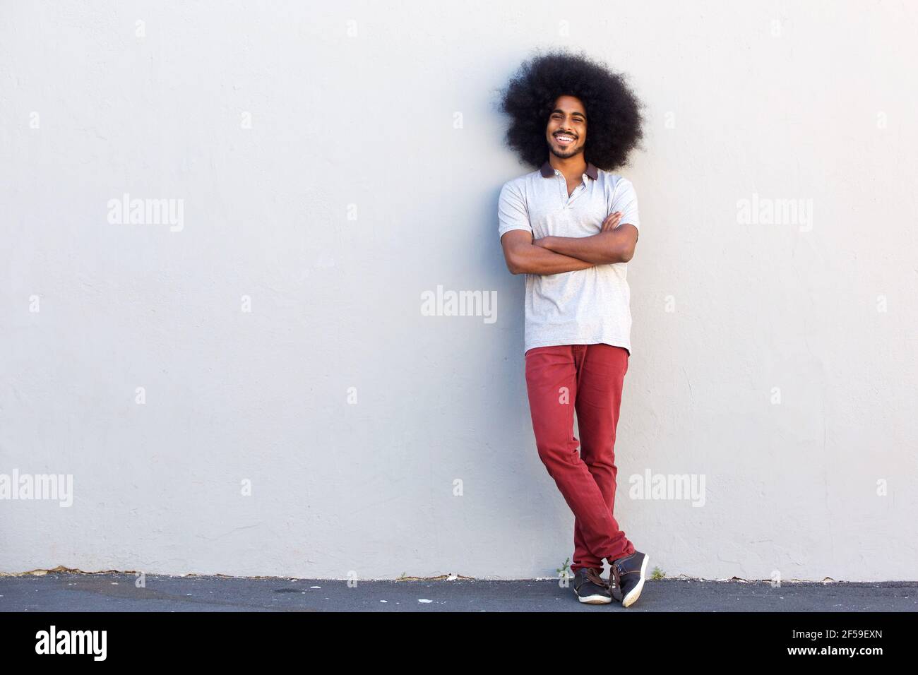 Full length portrait of happy afro man standing with arms crossed Stock ...