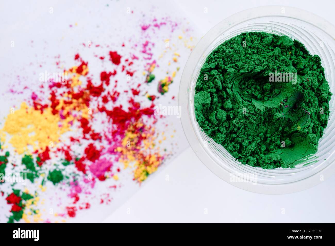 Holi colours powder scattered on white background with Pink or Gulabi ...