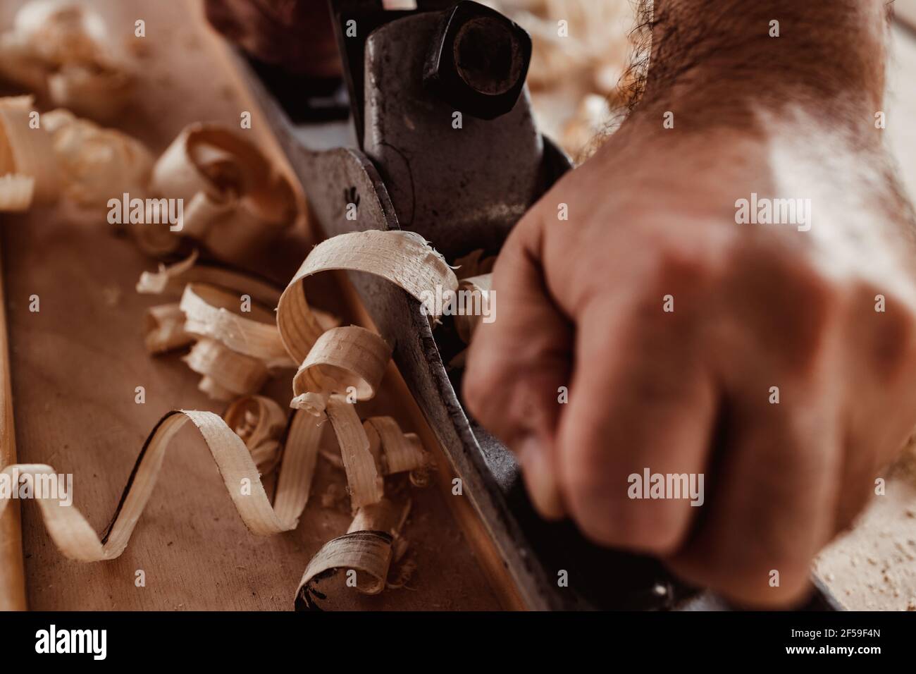 Carpenter's hands planing a plank of wood with a hand plane Stock Photo ...