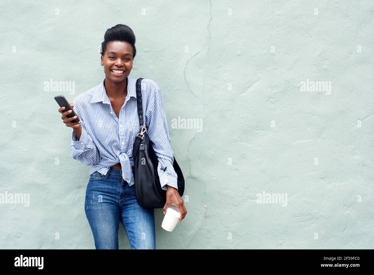 Portrait of beautiful black woman holding cellphone Stock Photo - Alamy