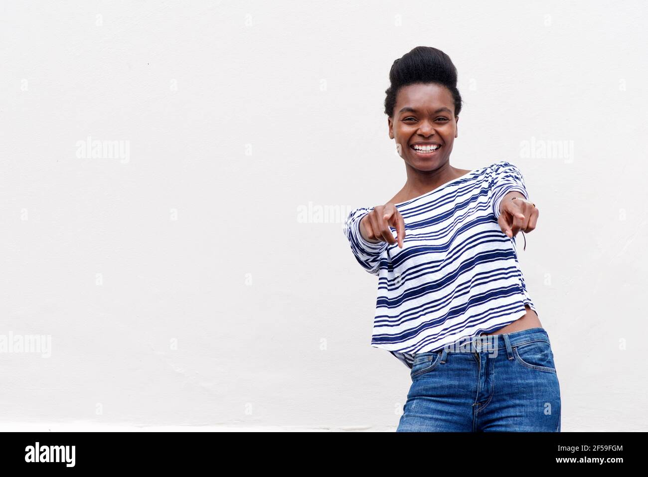 Portrait of cool african young woman pointing fingers Stock Photo - Alamy