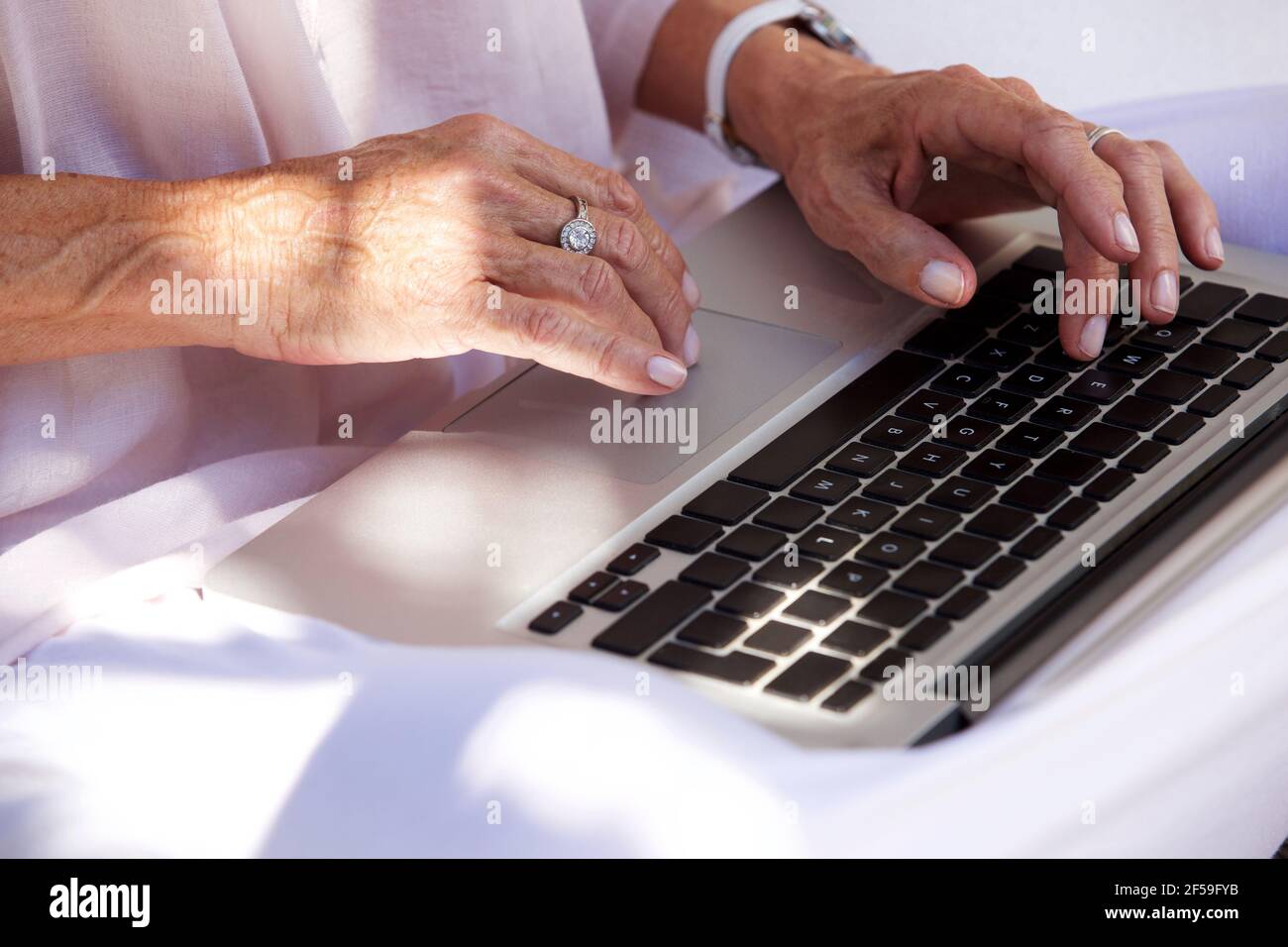 Hands on elderly woman typing hi-res stock photography and images - Alamy