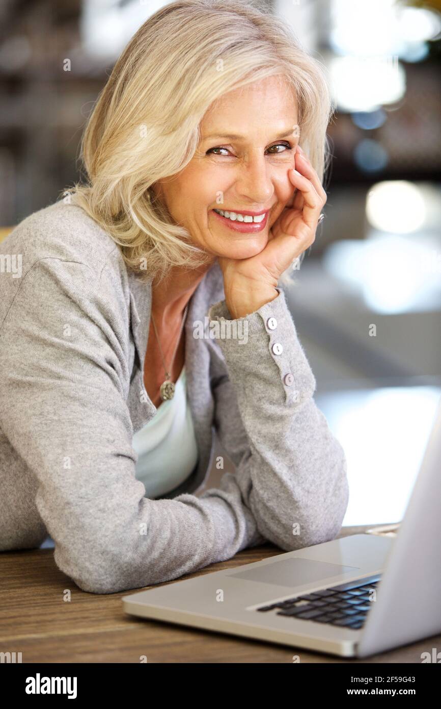 Close up portrait of happy older woman with laptop computer Stock Photo ...