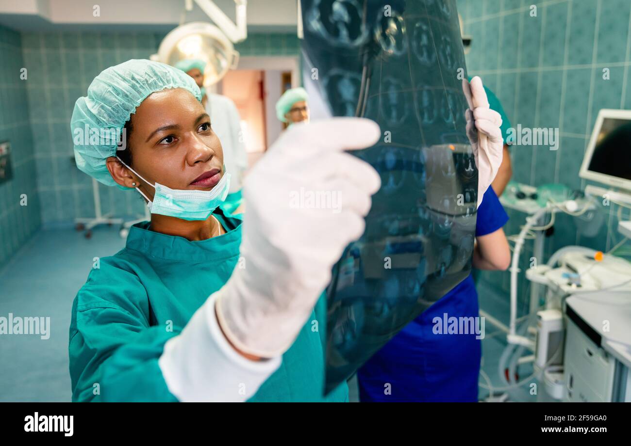 Female doctor looking at ct scan in hospital before surgery Stock Photo ...