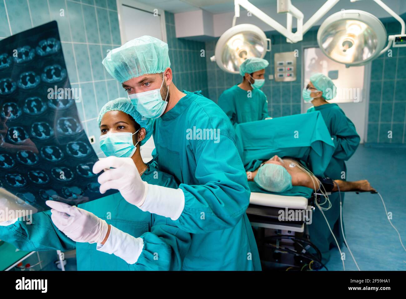 Portrait of a successful medical surgeon team inside operating room ...
